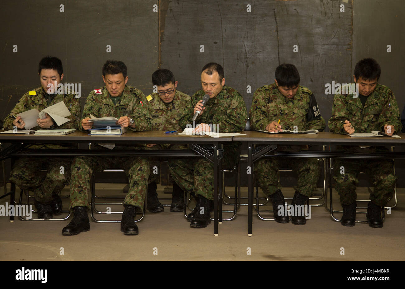 A Soldier with the Japan Ground Self-Defense Force reads off his notes ...