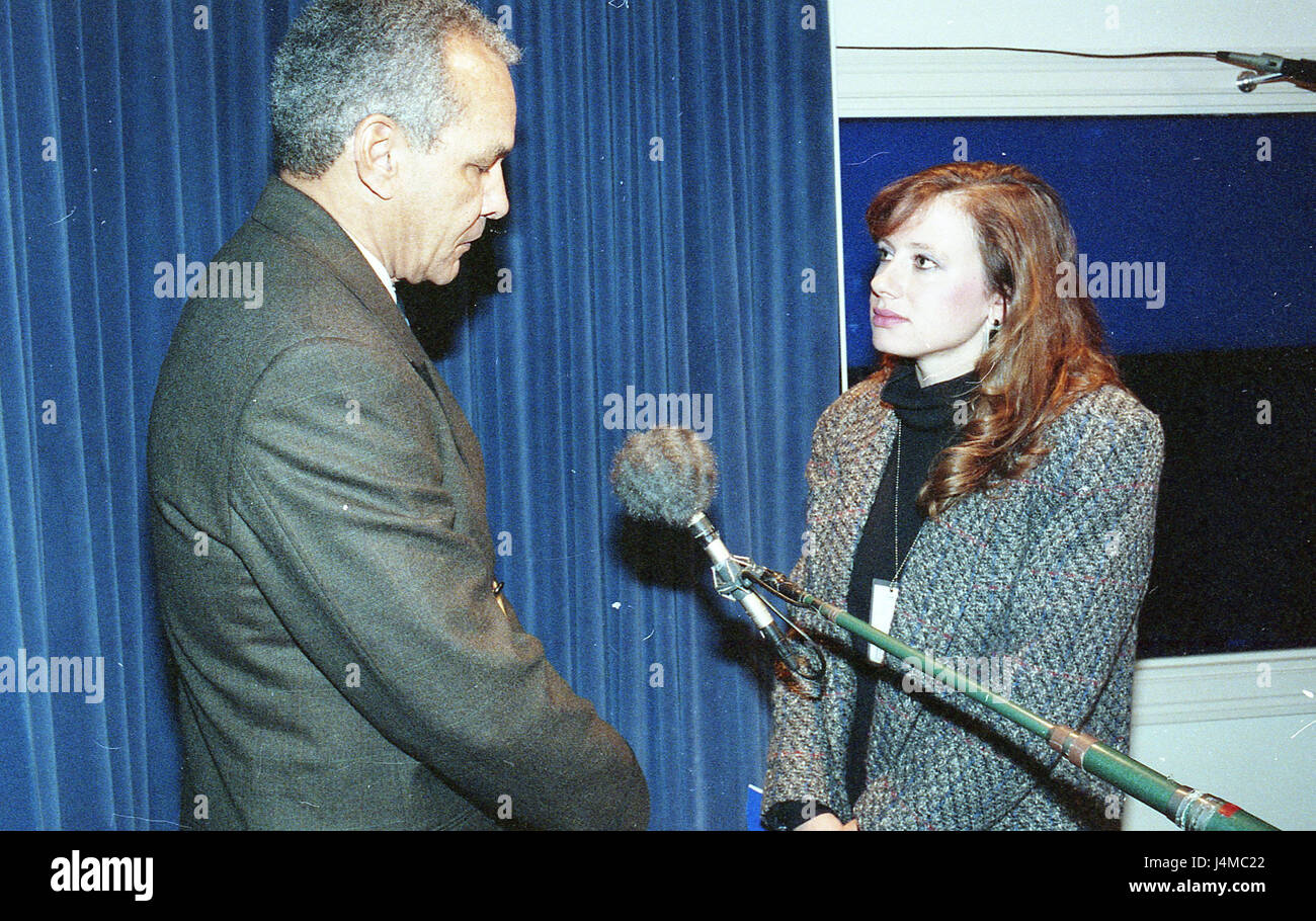 A FEMALE REPORTER IS INTERVIEWING A MAN Stock Photo - Alamy