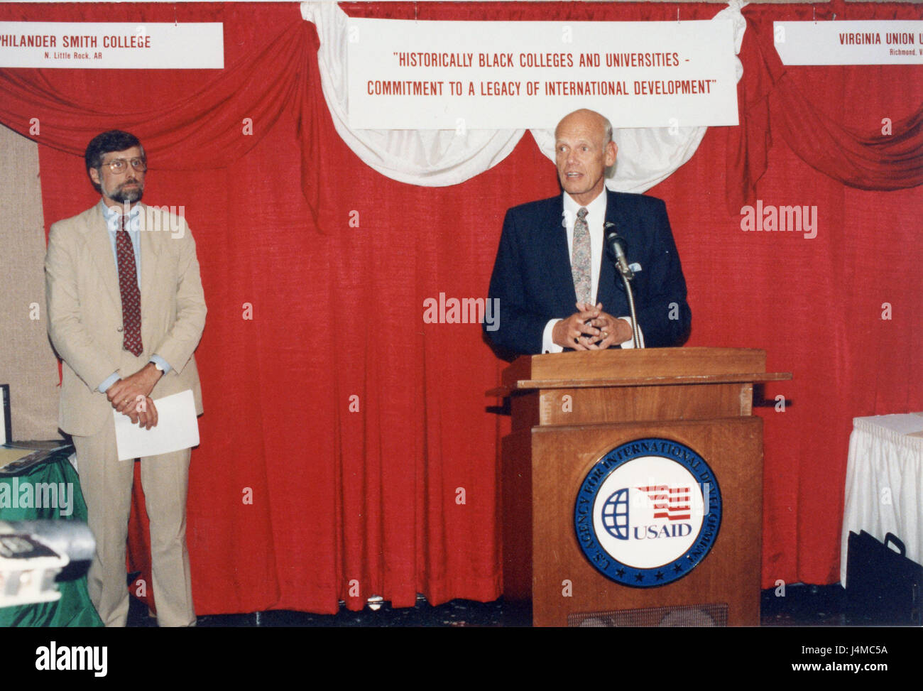 man standing at podium speaking Stock Photo - Alamy