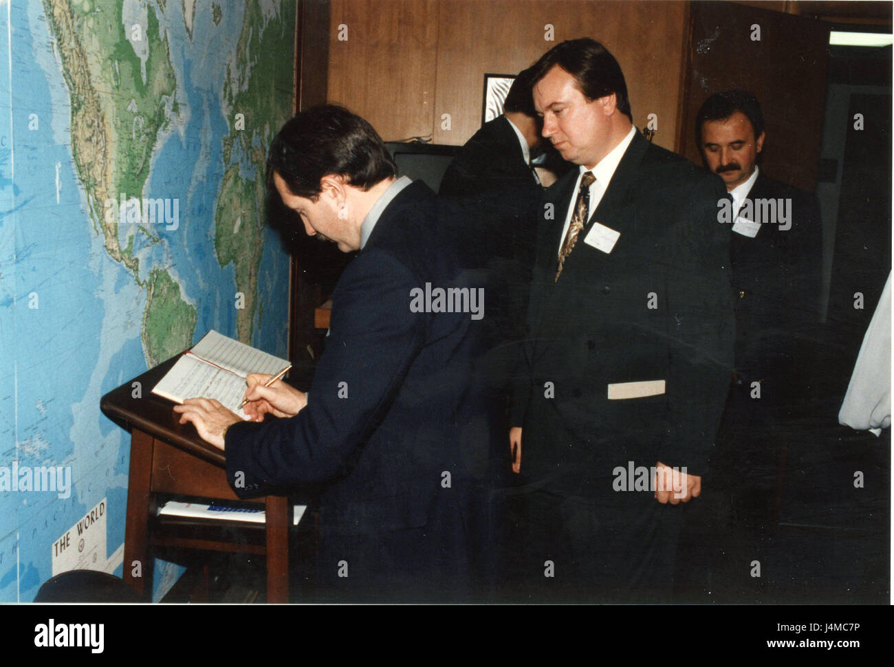 men writing in book Stock Photo - Alamy