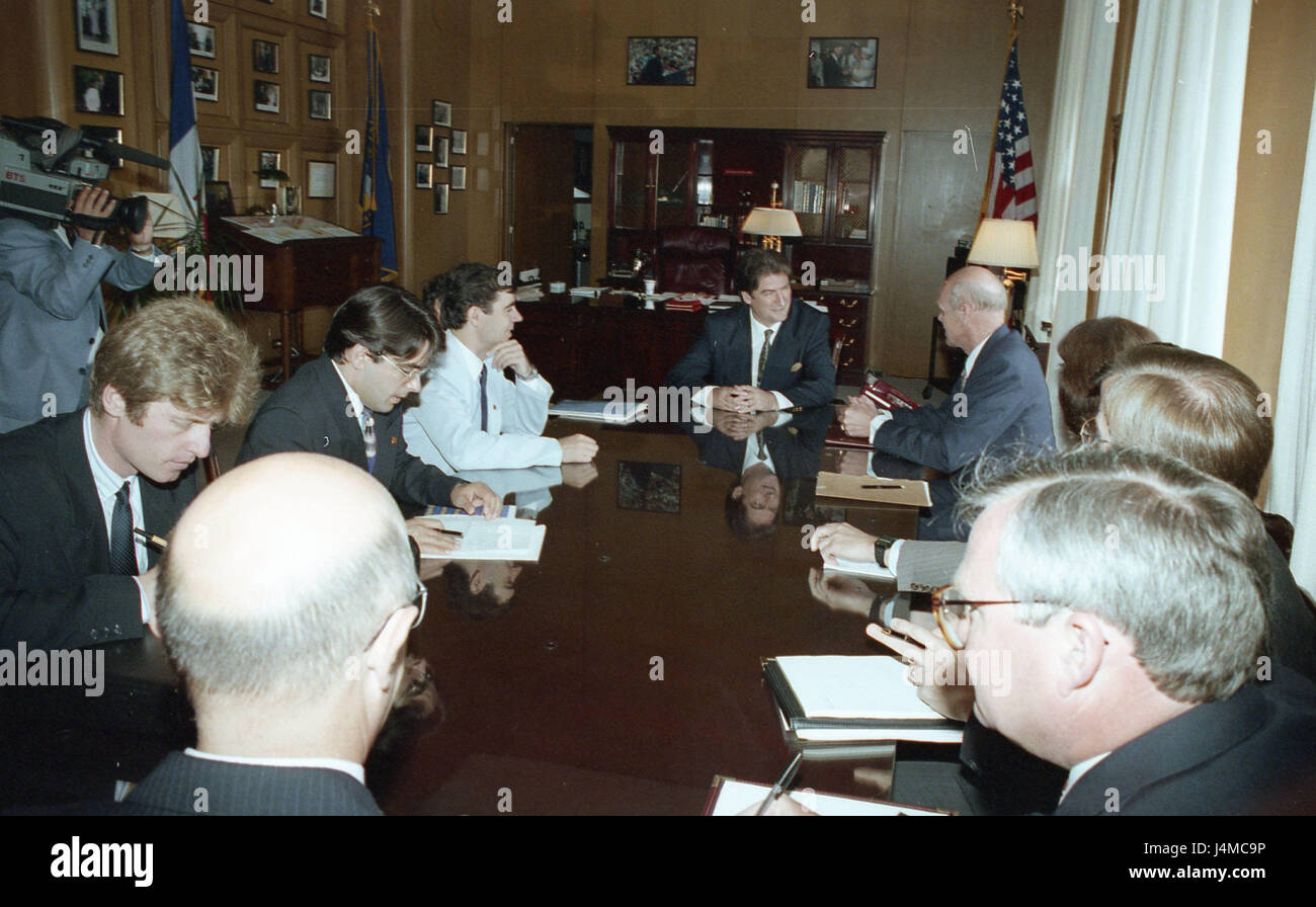 men and woman sitting at conference table Stock Photo - Alamy