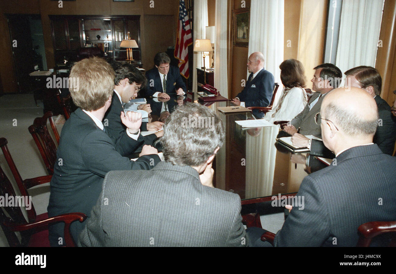 men and woman sitting at conference table Stock Photo - Alamy