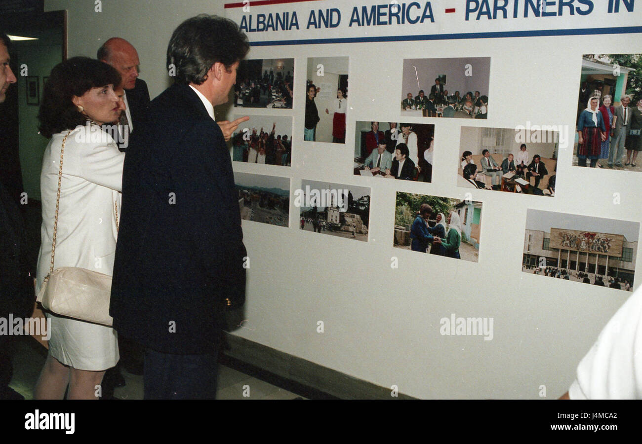 MEN AND WOMAN LOOKING AT POSTER Stock Photo - Alamy