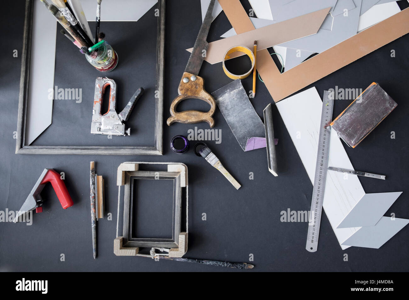 Picture frame and tools on table Stock Photo - Alamy