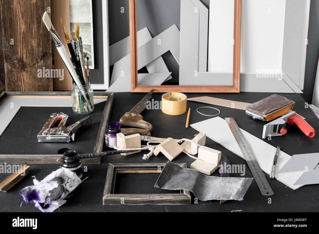 Picture frame and tools on tables Stock Photo - Alamy