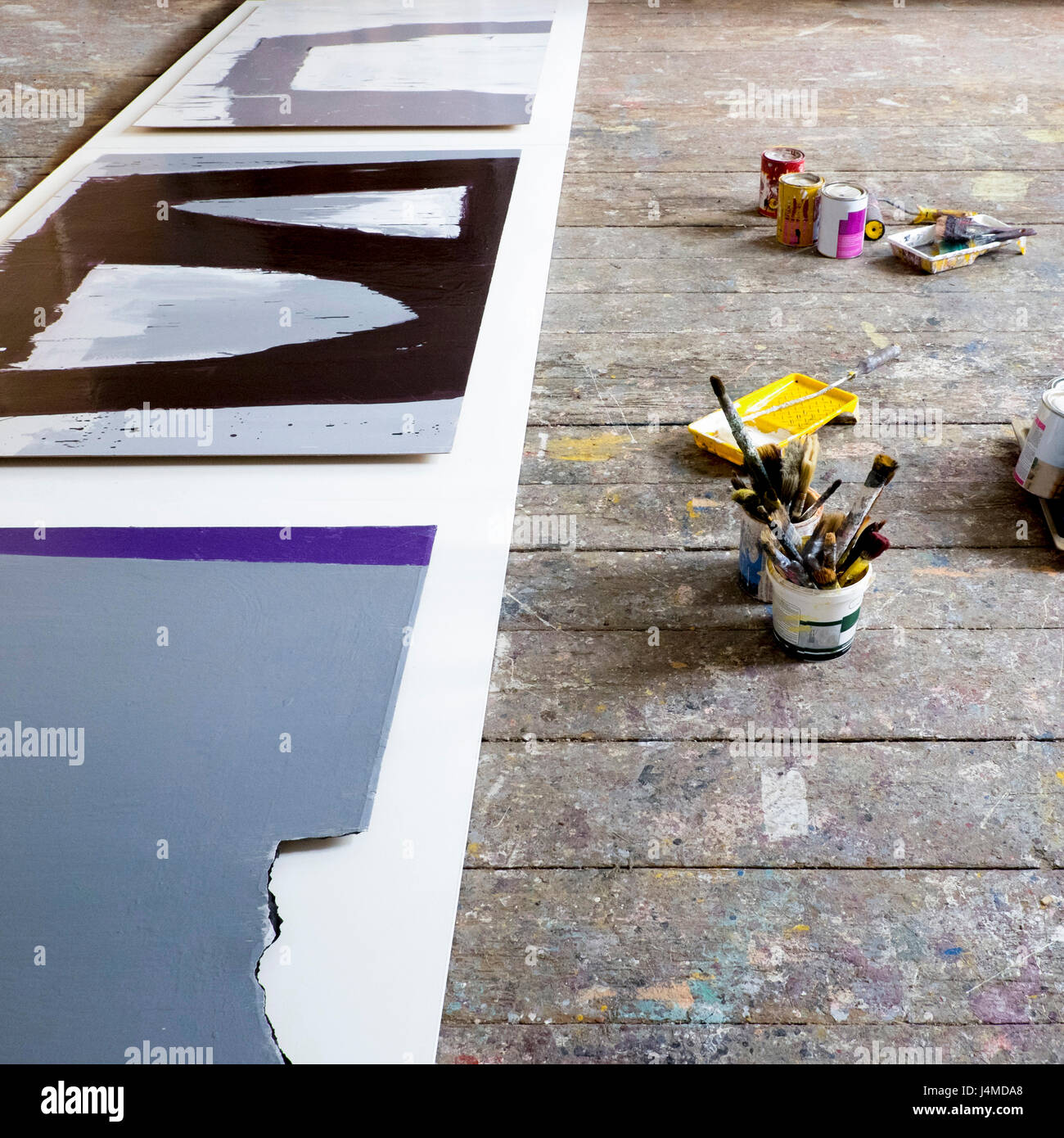 Paint supplies on floor of art studio Stock Photo - Alamy