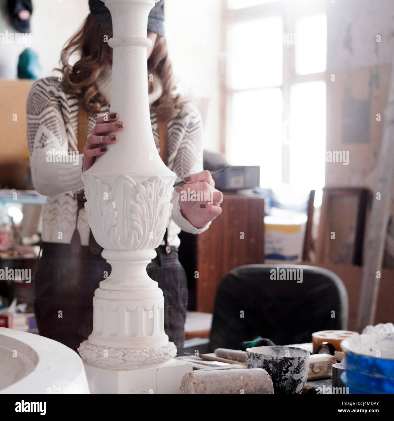 Caucasian artist sculpting with tool Stock Photo - Alamy