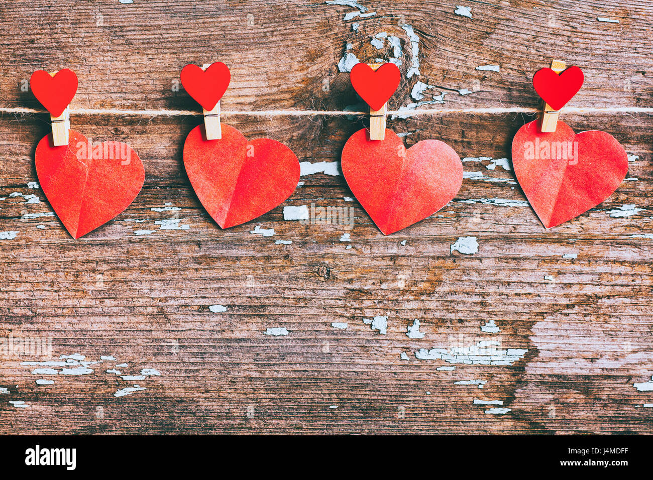 Paper hearts hanging on string with clothespin Stock Photo - Alamy