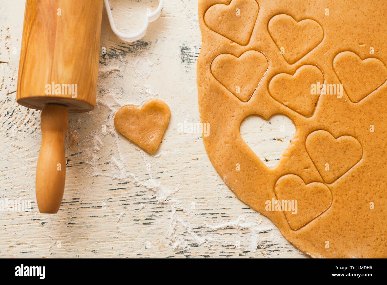 Heart shape cut from cookie dough Stock Photo - Alamy