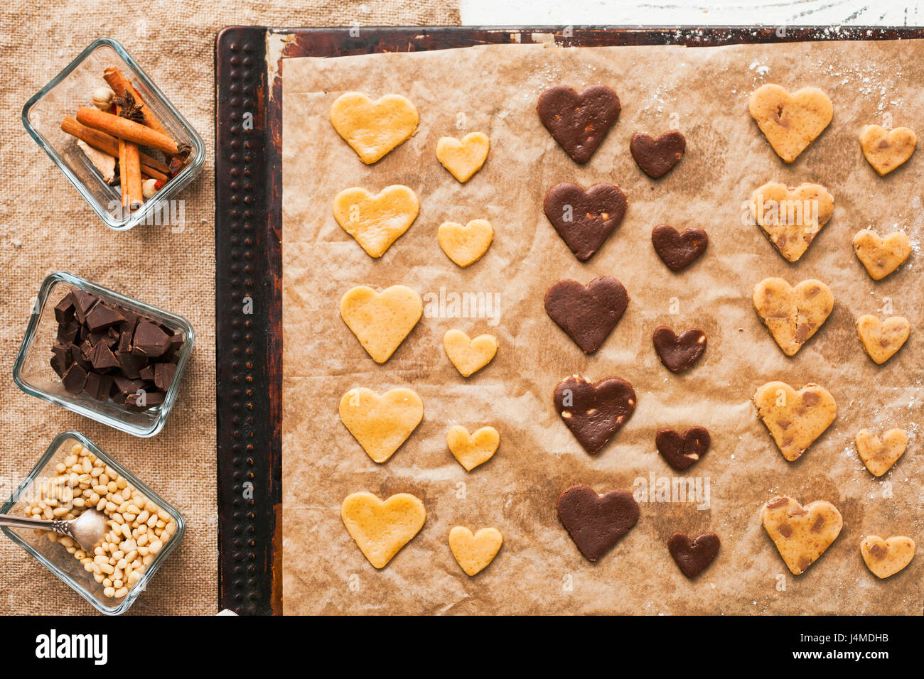 Heart-shape cookies on baking sheet near ingredients Stock Photo - Alamy