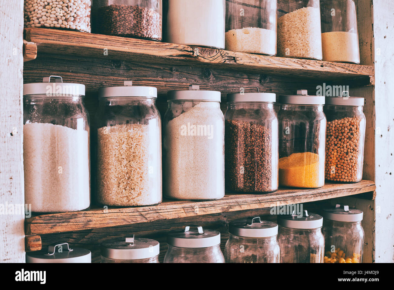 Jars of ingredients on wooden shelves Stock Photo - Alamy