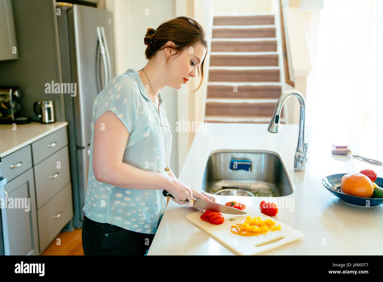 Woman chopping food in domestic kitchen Stock Photo - Alamy