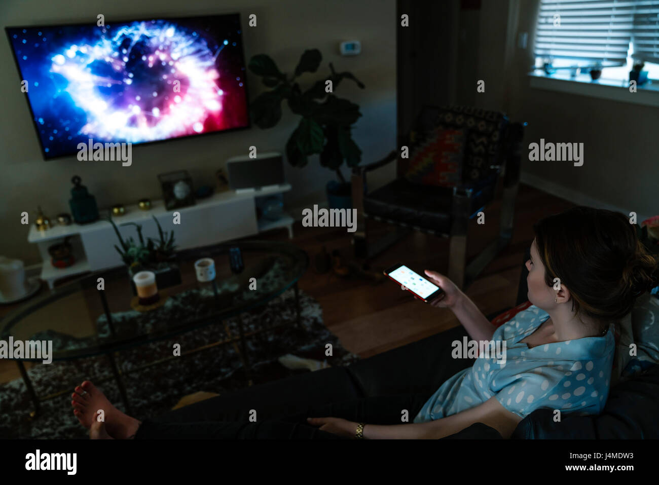 Woman watching tv using hi-res stock photography and images - Alamy