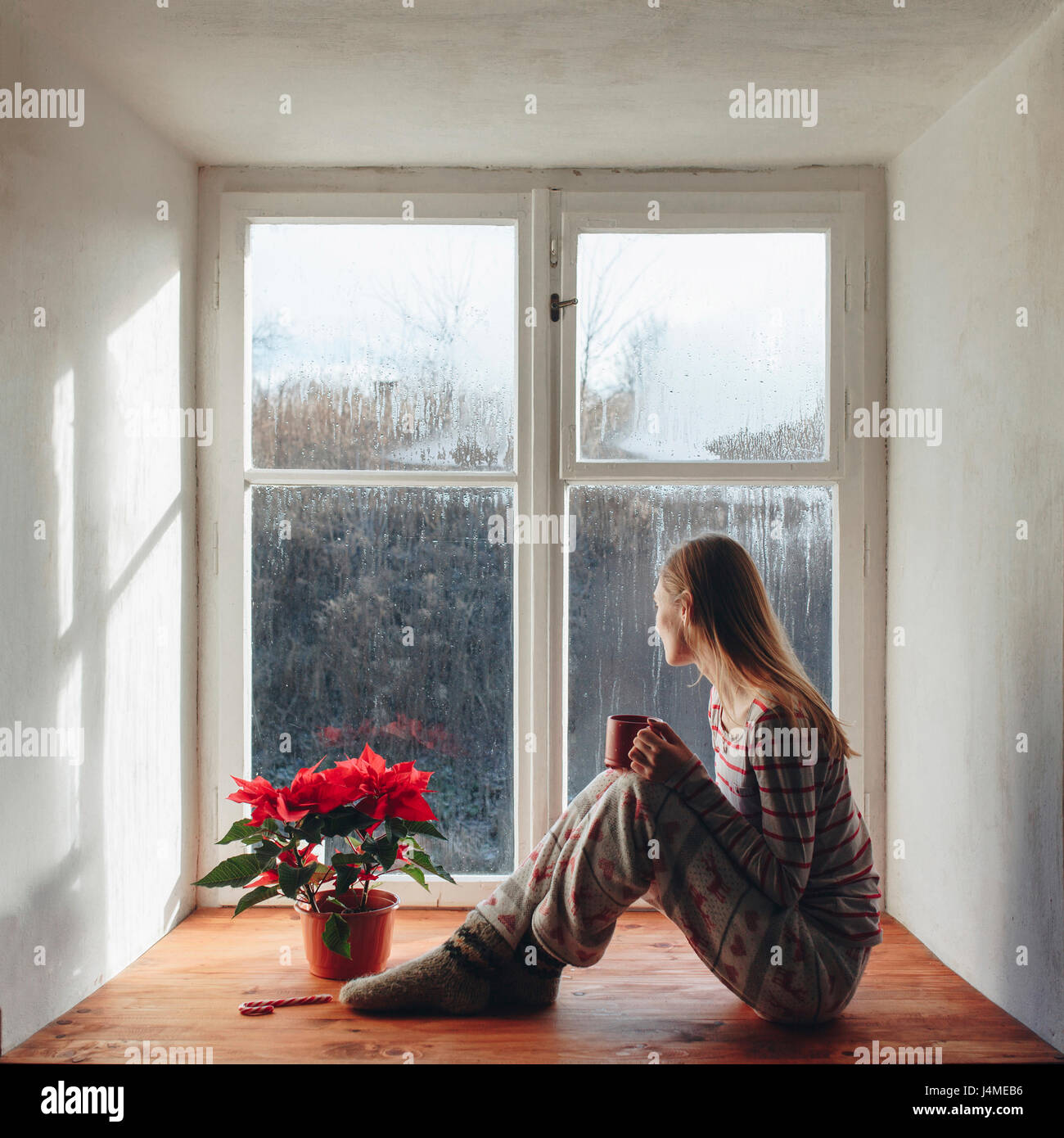 Woman sitting window sill hi-res stock photography and images - Alamy