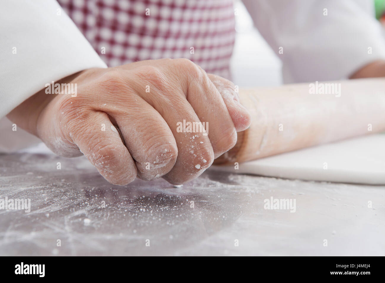 Hands of Hispanic woman using rolling pin on dough Stock Photo - Alamy