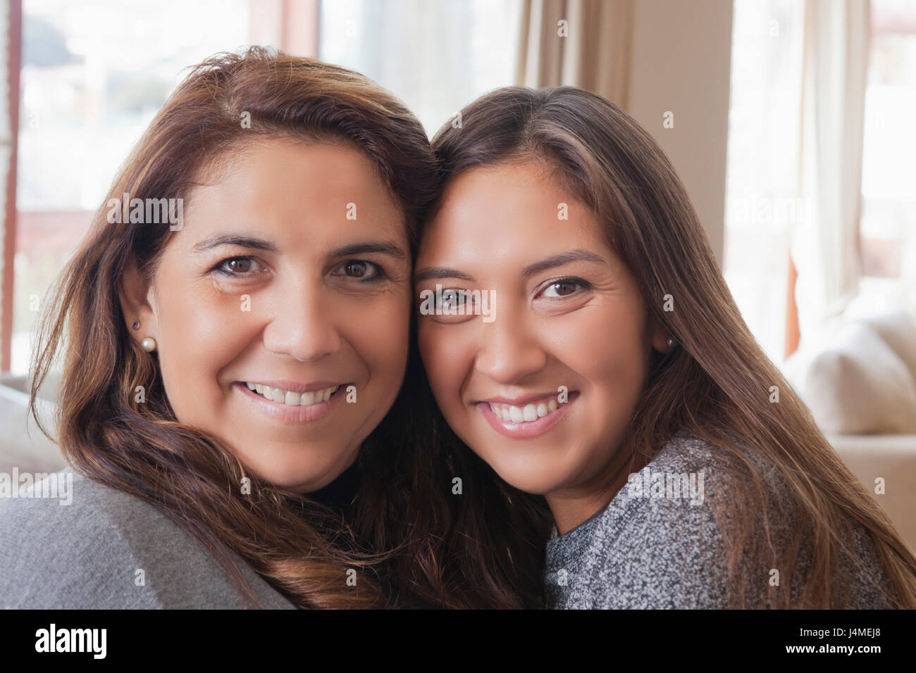 Smiling Hispanic mother and daughter posing cheek to cheek Stock Photo ...