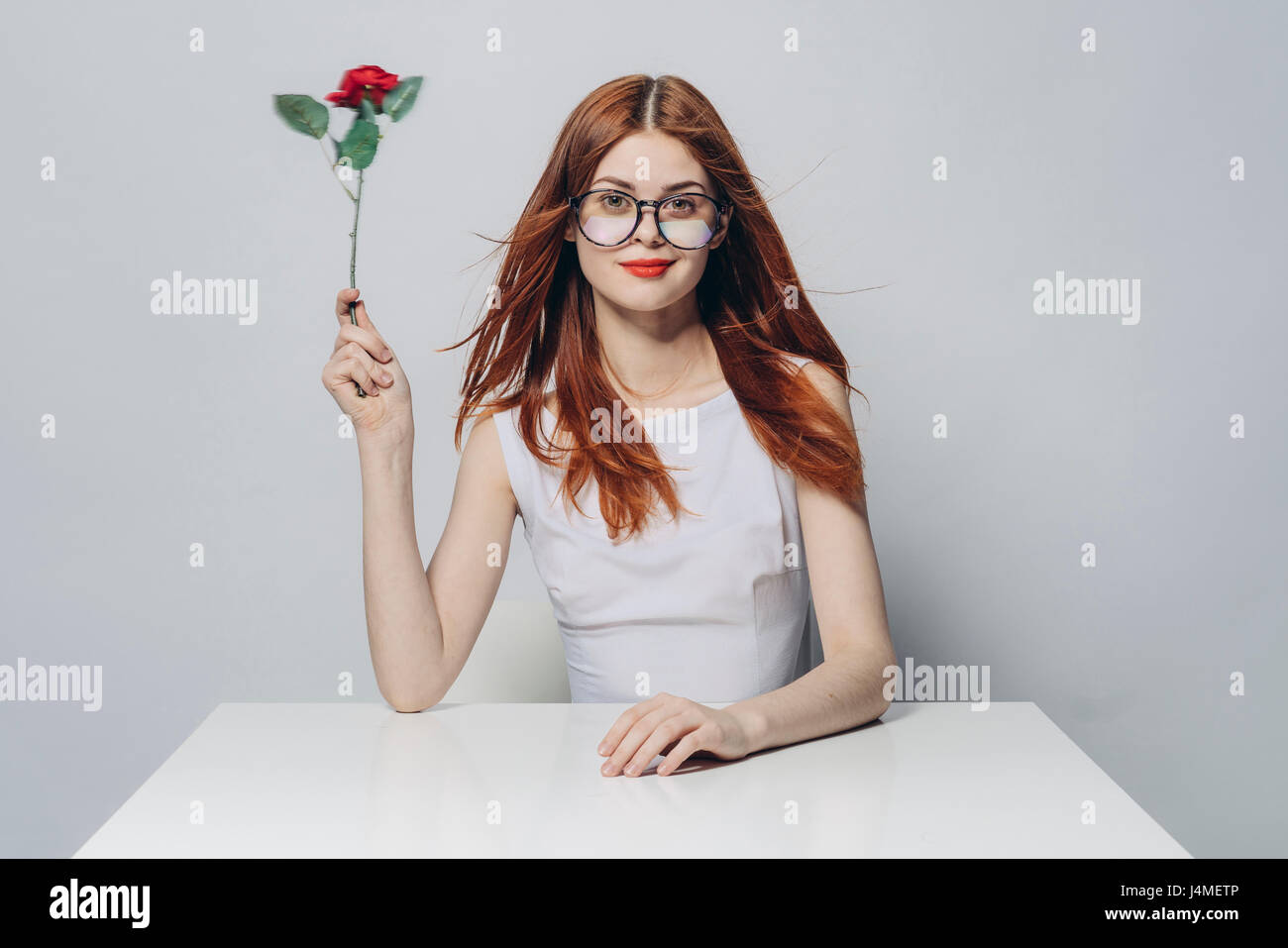 Smiling lady red rose looking hi-res stock photography and images - Alamy
