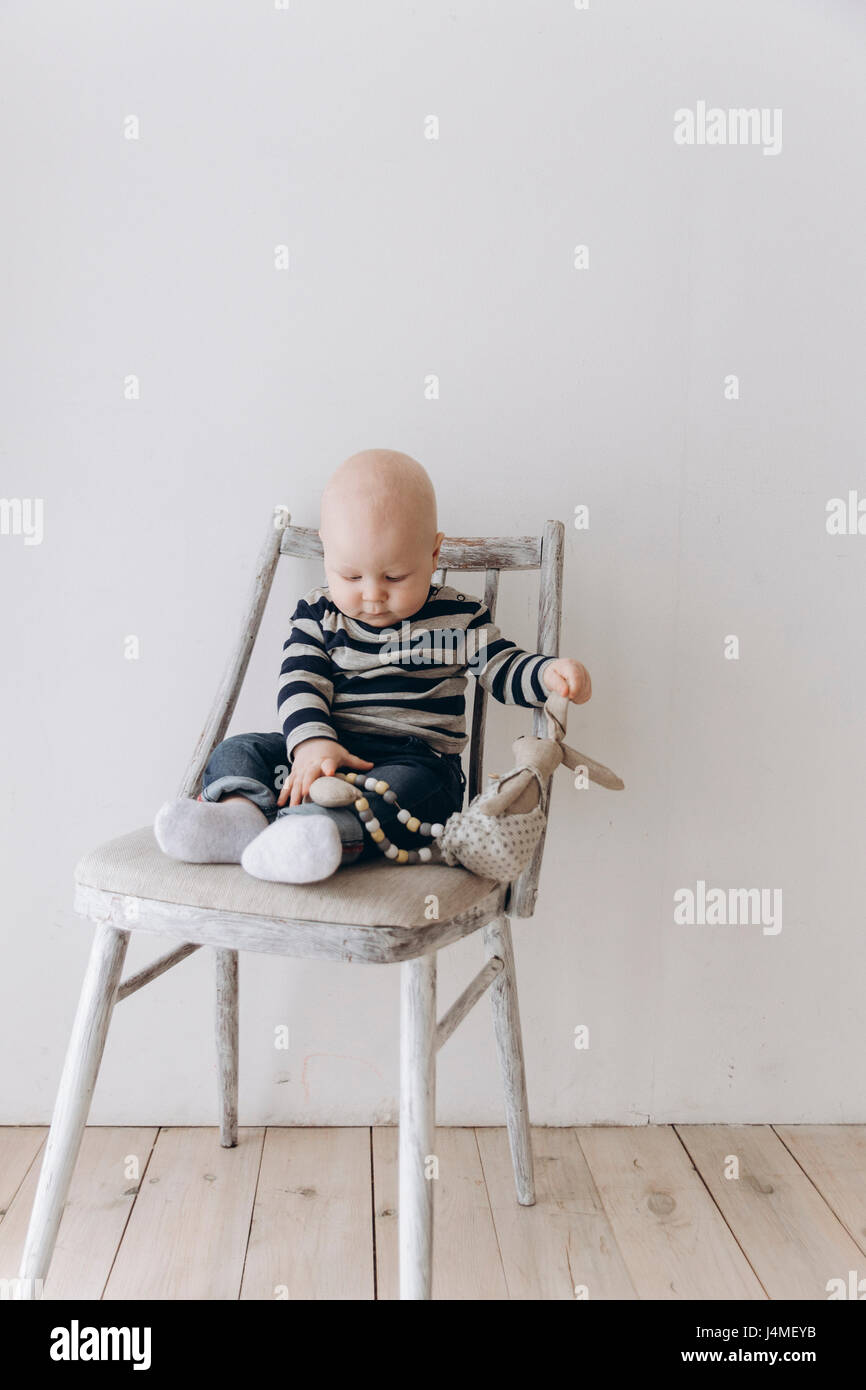 Boy by chair hi-res stock photography and images - Alamy