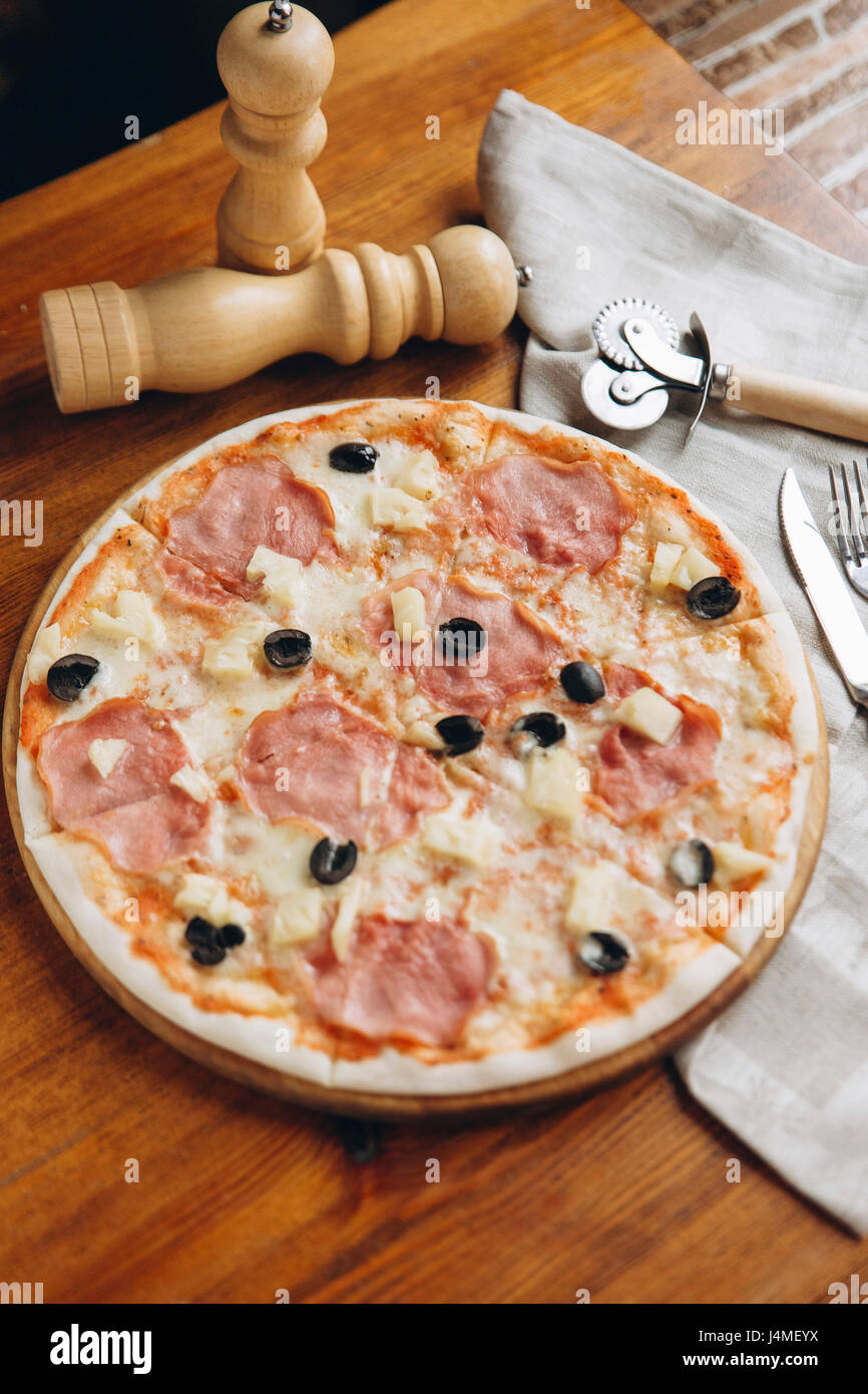 Pizza pie on table Stock Photo - Alamy