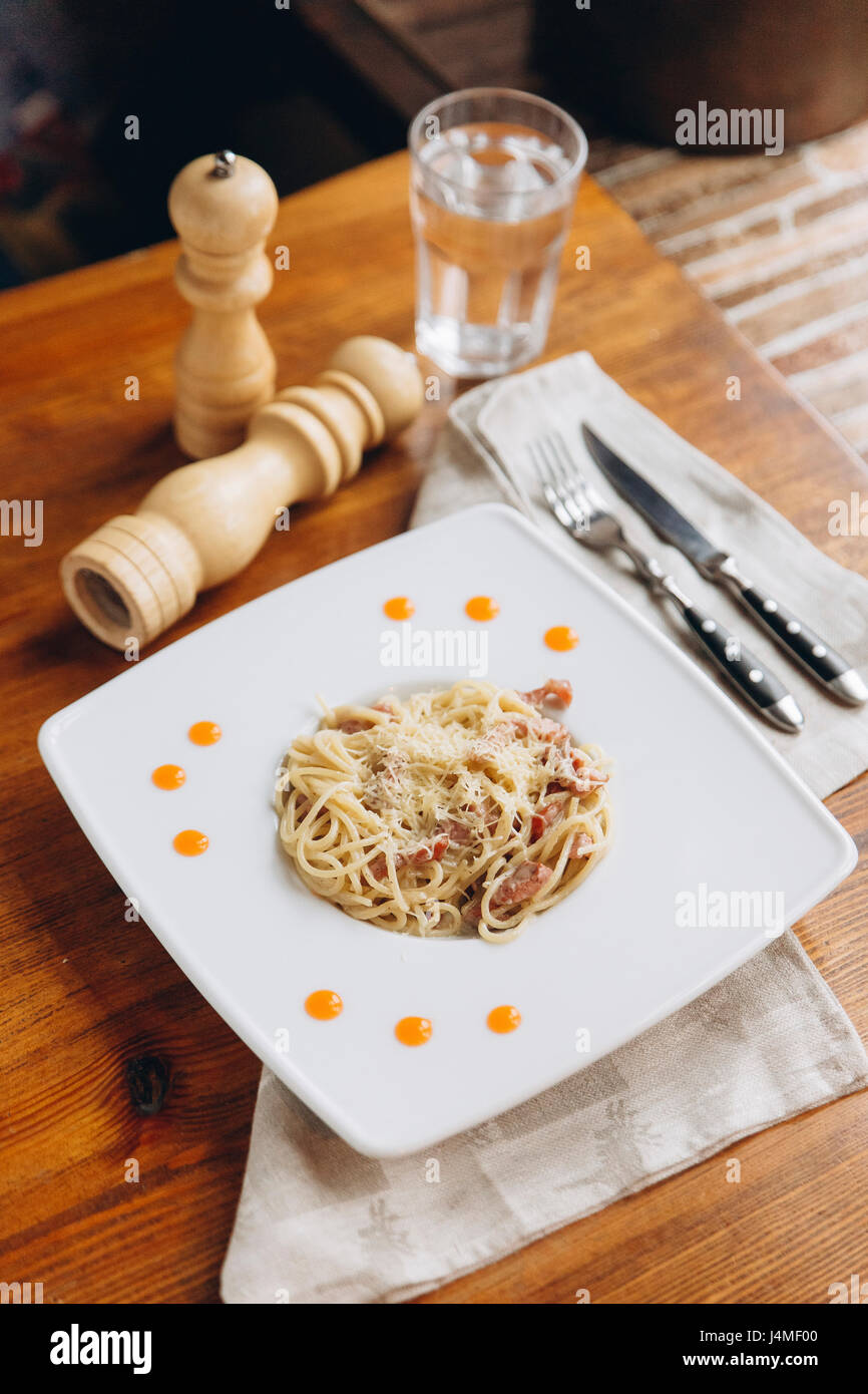 Plate of pasta on table Stock Photo - Alamy