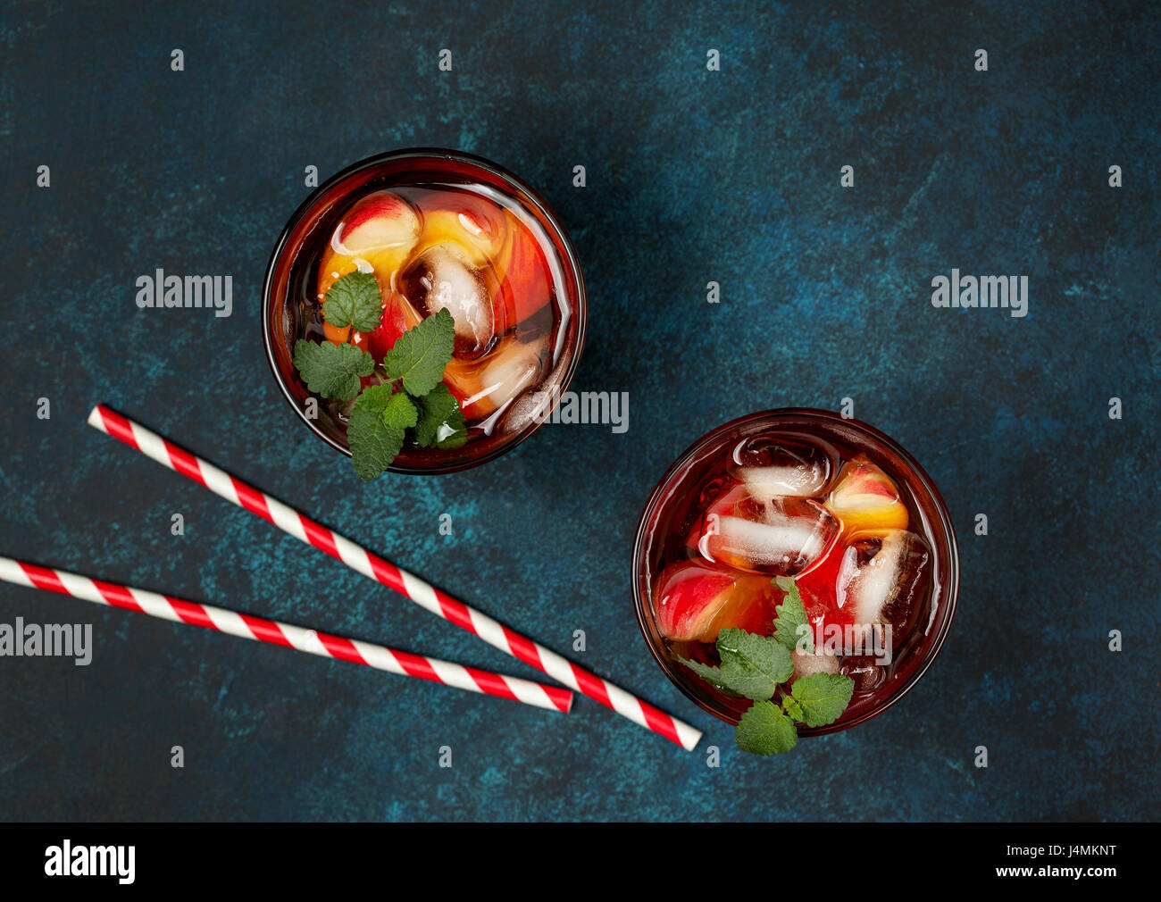 Peach ice tea in glass on concrete blue background. view from above ...