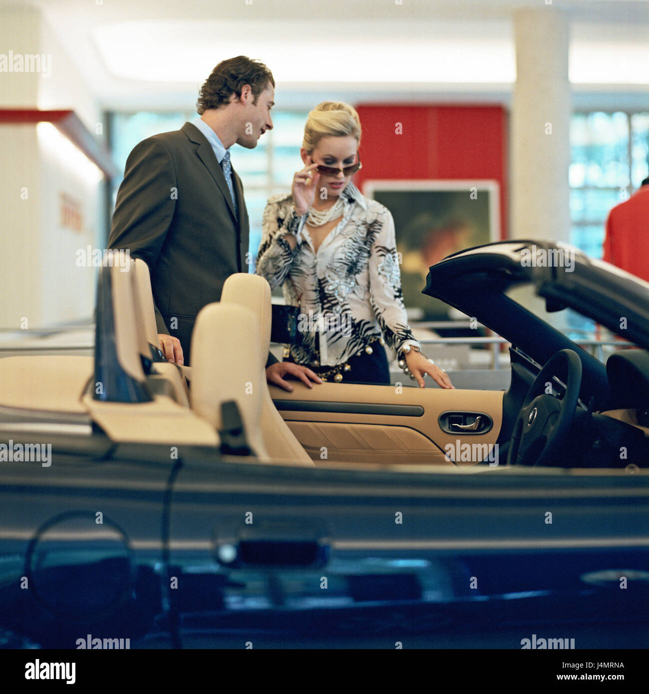 Car dealer, showroom, couple, elegantly, car buying, convertible, look ...
