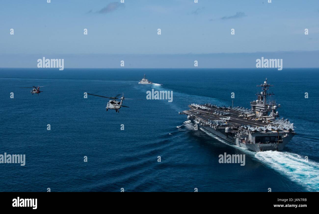 The U.S. Navy Nimitz-class nuclear aircraft carrier USS Theodore Roosevelt under escort by ...