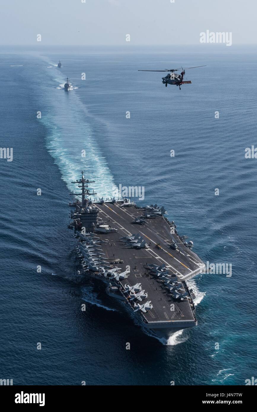 The U.S. Navy Nimitz-class nuclear aircraft carrier USS Theodore Roosevelt under escort by ...