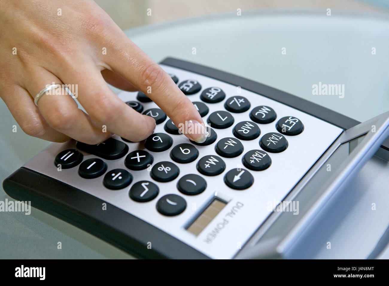 Women's hand, electronic calculator, serve Stock Photo - Alamy