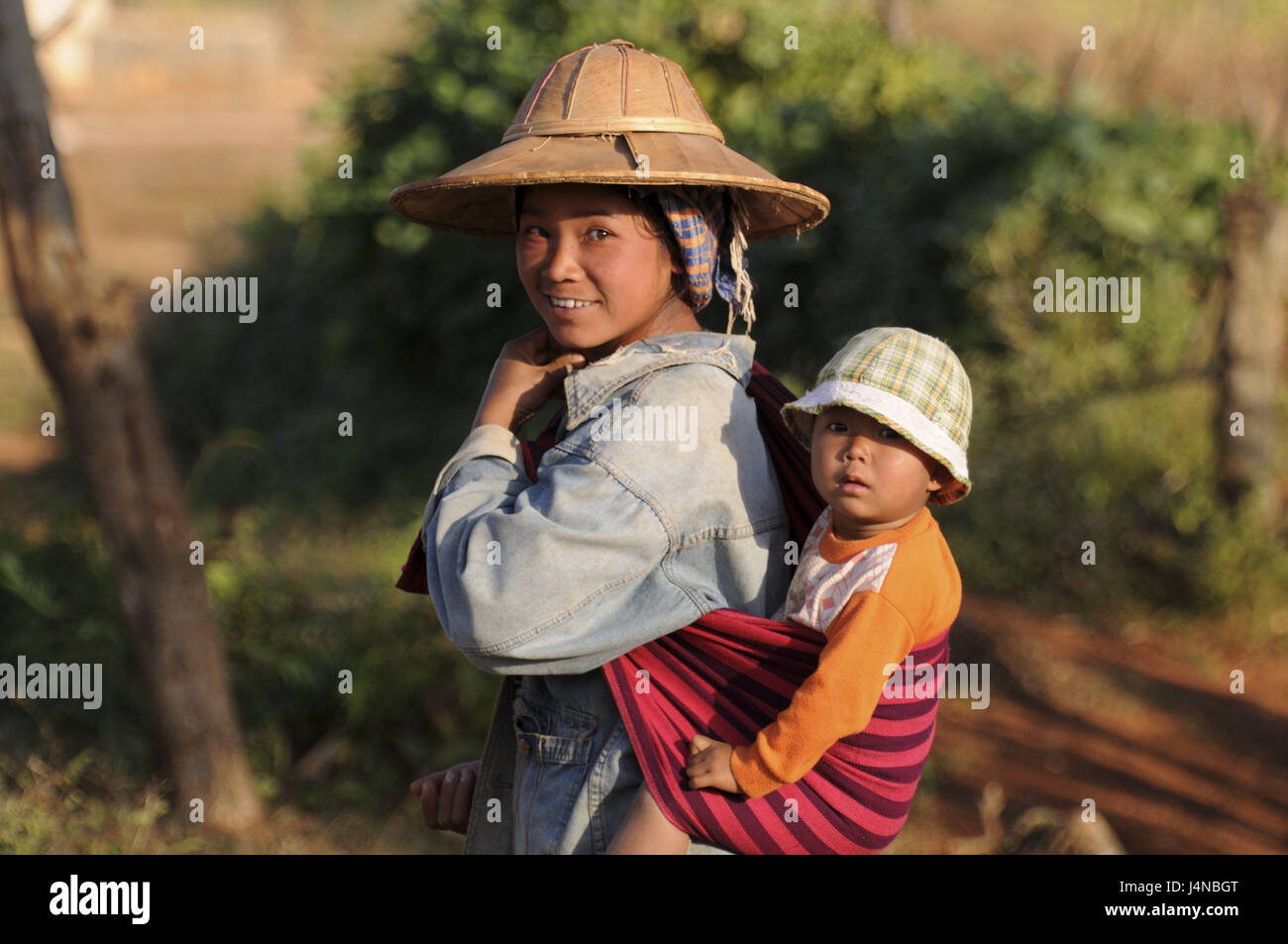 Woman carry child back hi-res stock photography and images - Alamy