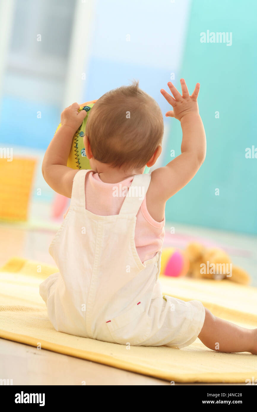 Baby, 8 months, toys, play, back view Stock Photo - Alamy