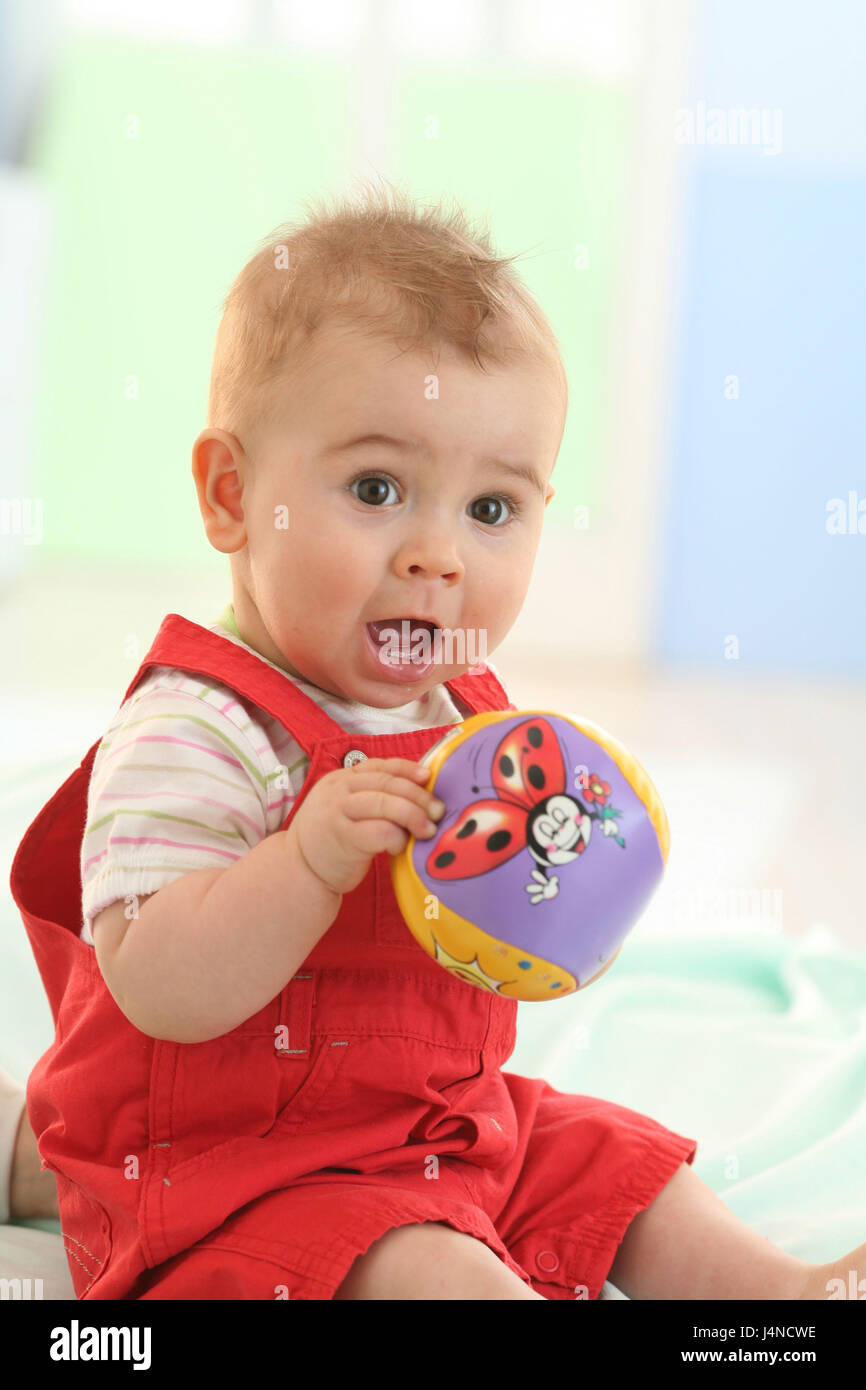 Baby, 8 months, ball, hold, play Stock Photo - Alamy