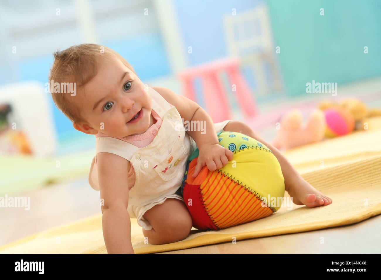 Baby, 8 months, smile, play substance ball Stock Photo - Alamy