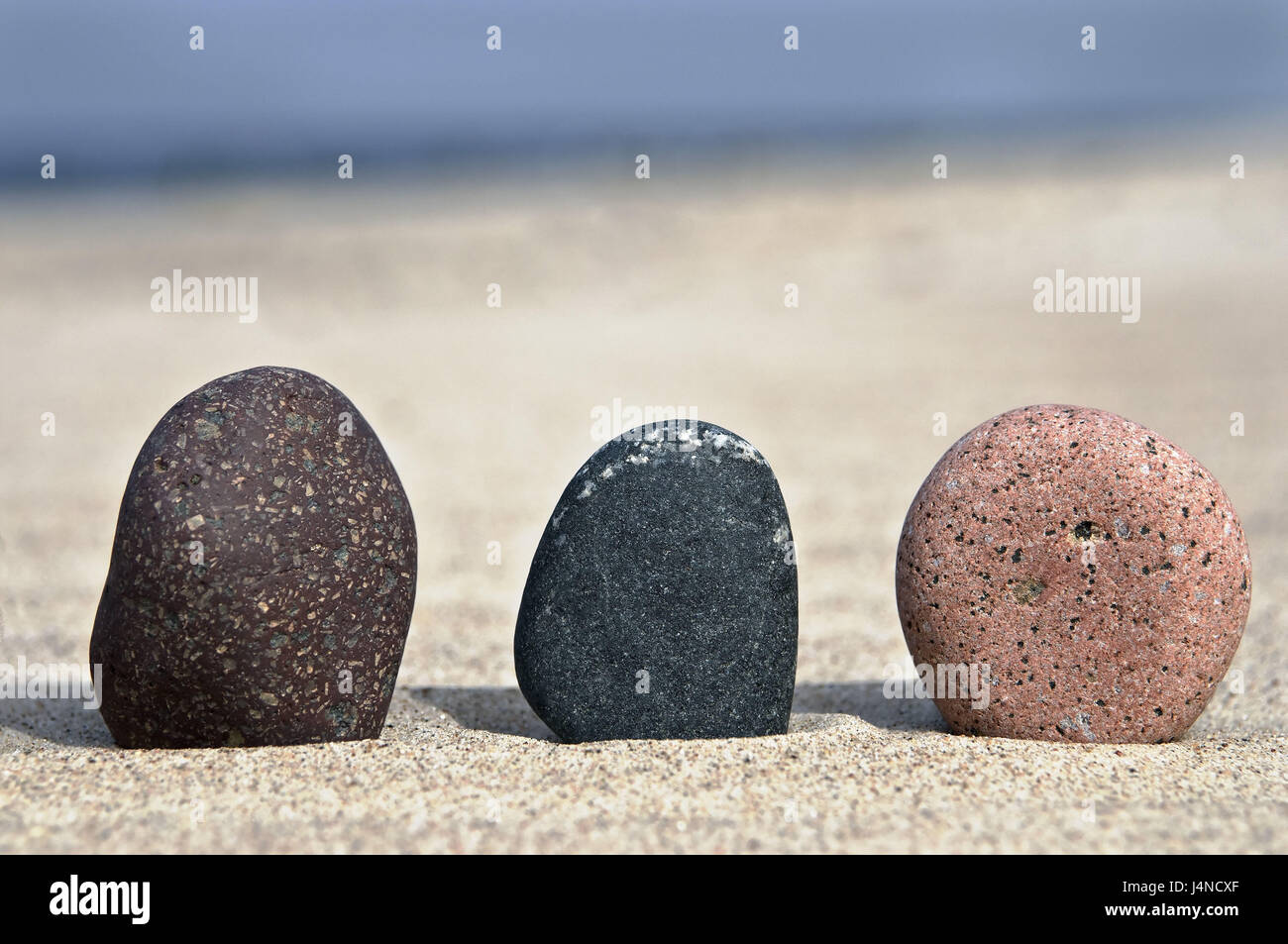 Sandy beach, stones, side by side Stock Photo - Alamy