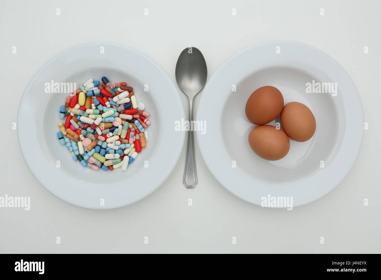Drugs, plates, tablets, capsules, eggs, spoons Stock Photo - Alamy
