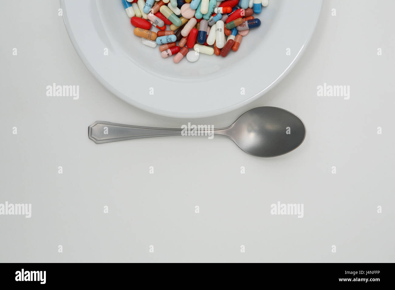 Drugs, plates, tablets, capsules, spoon, curled Stock Photo - Alamy
