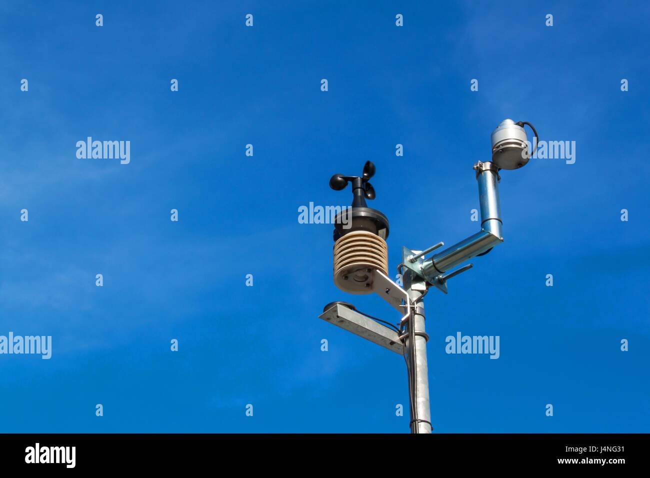 Anemometer on blue sky. Weather measuring instrument wind cup meter and ...