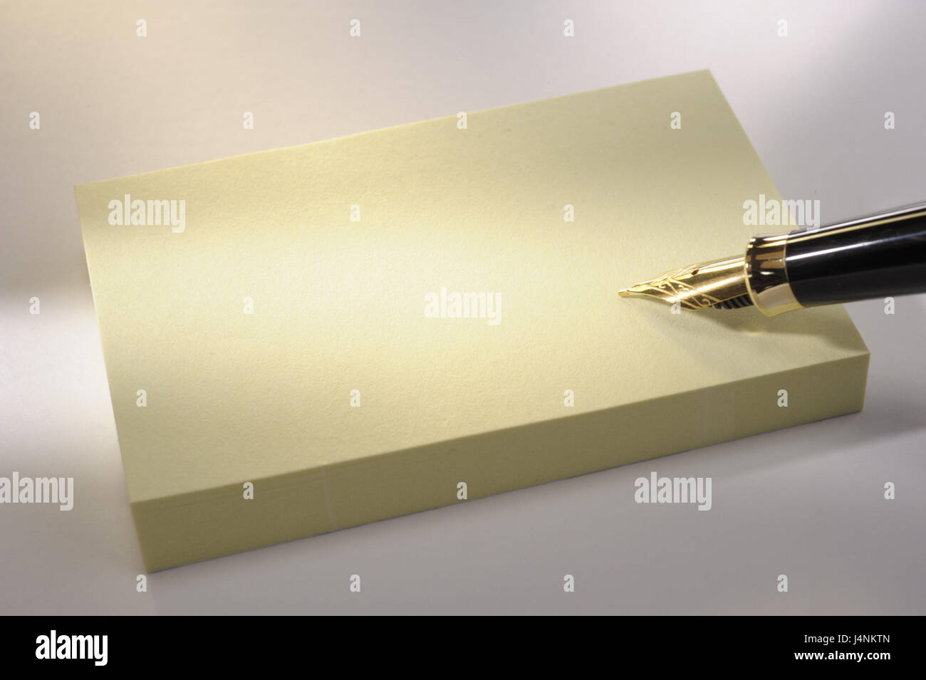 Note slip of paper with pen Stock Photo - Alamy