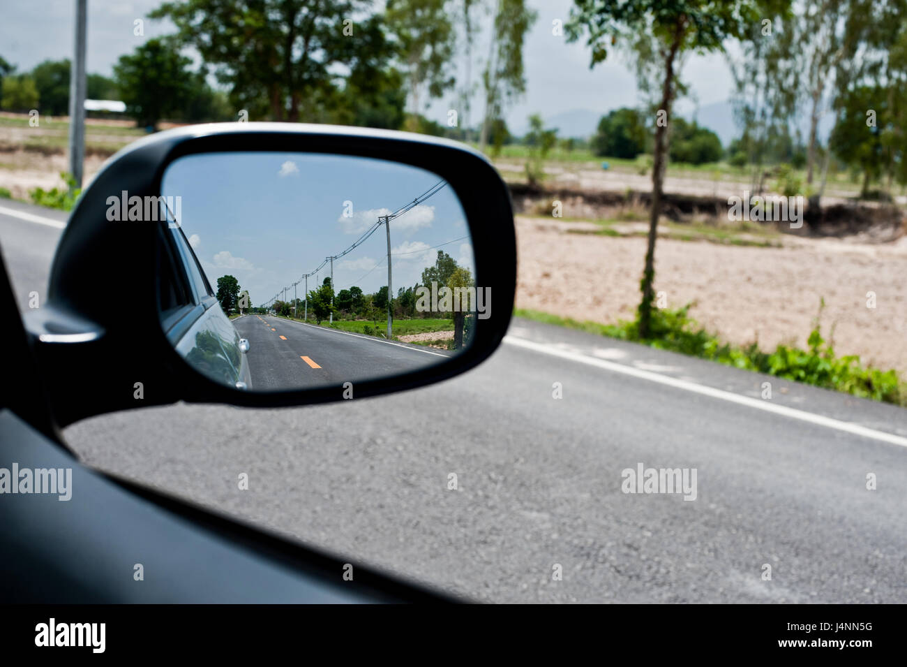 Landscape in the sideview mirror of a car, on road countryside, natural ...