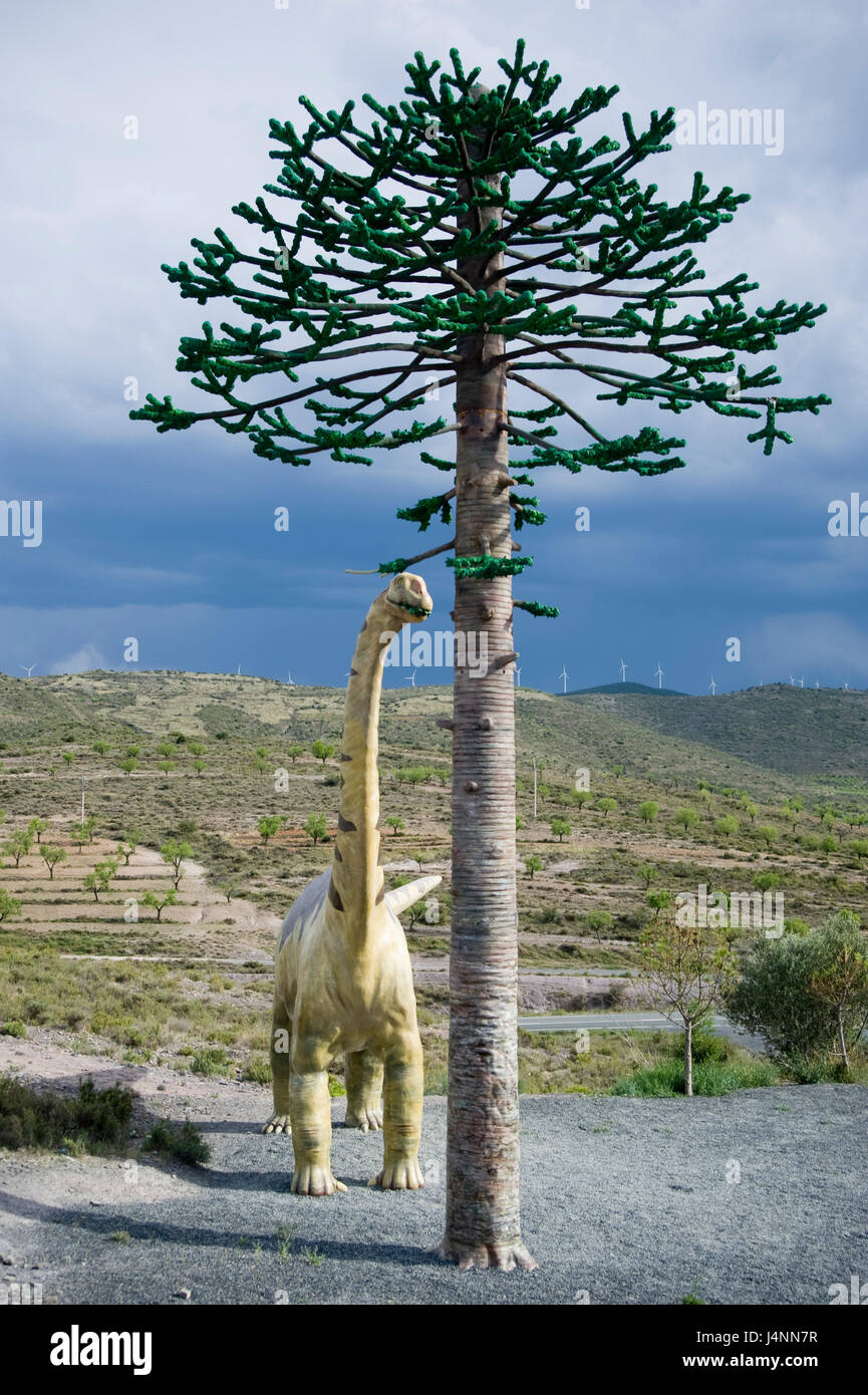 Replica of sauropod camarasaurus eating leafs of araucaria conifer tree ...
