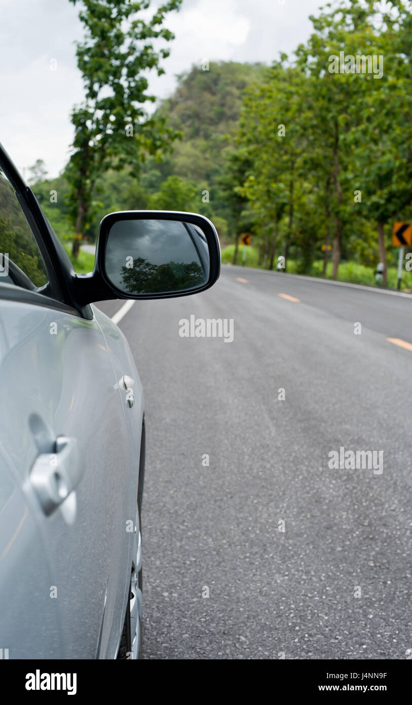 Rear side perspective view of car on road countryside Stock Photo - Alamy