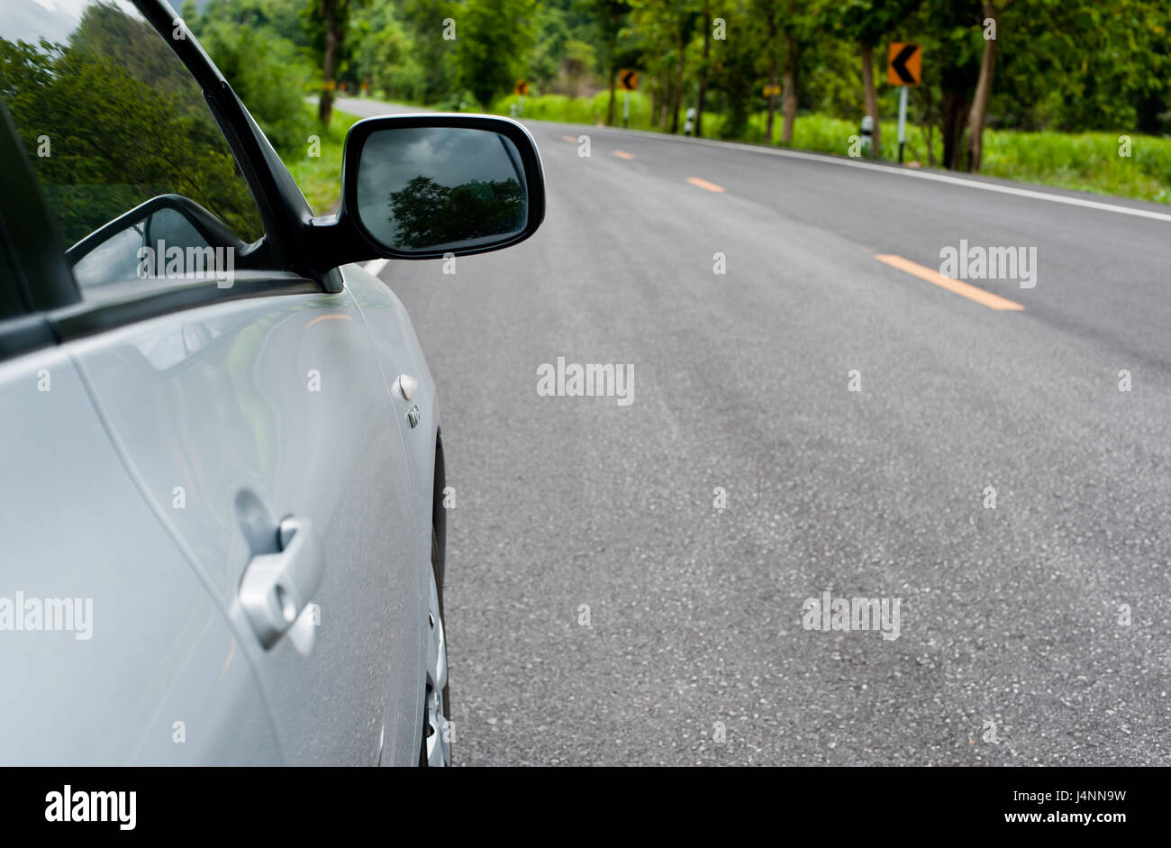 Rear side perspective view of car on road countryside Stock Photo - Alamy
