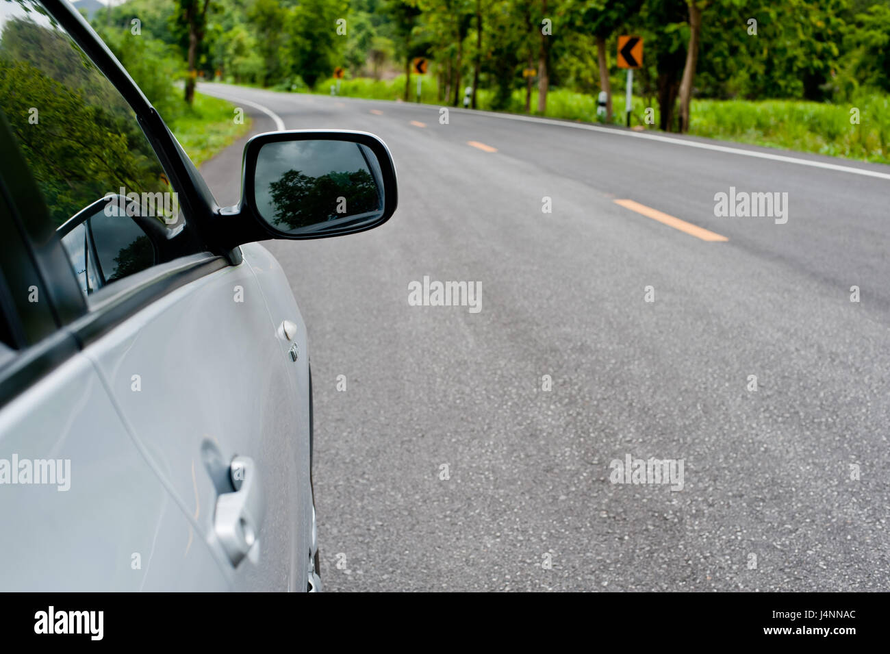 Rear side perspective view of car on road countryside Stock Photo - Alamy