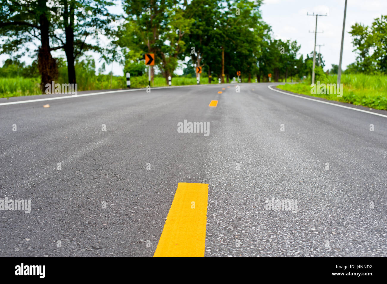 Close up asphalt surface of road divide yellow lines Stock Photo - Alamy