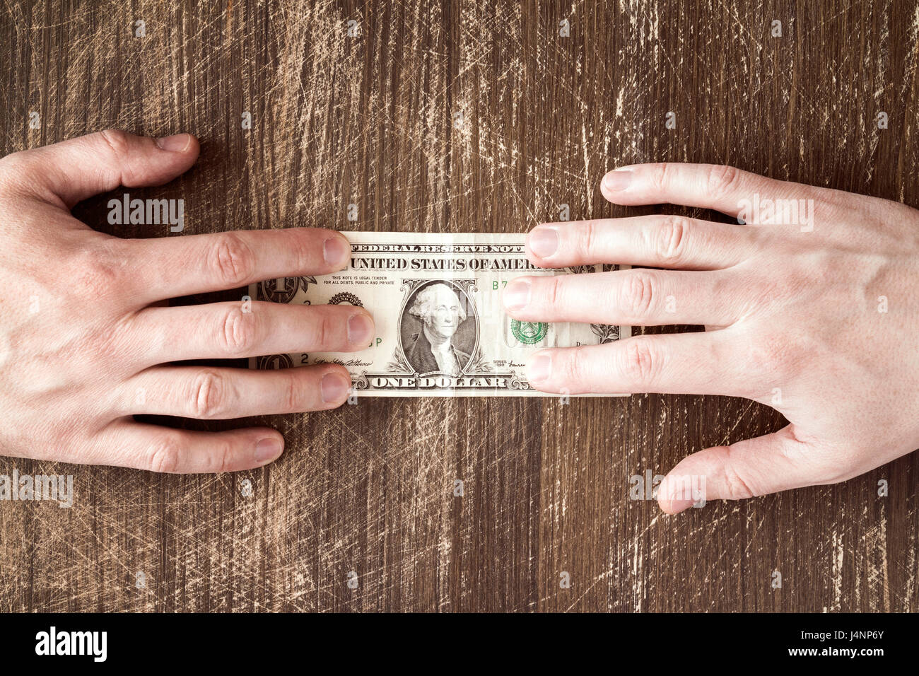 Hands pulling dollar banknote.Concept for business rivalry Stock Photo ...