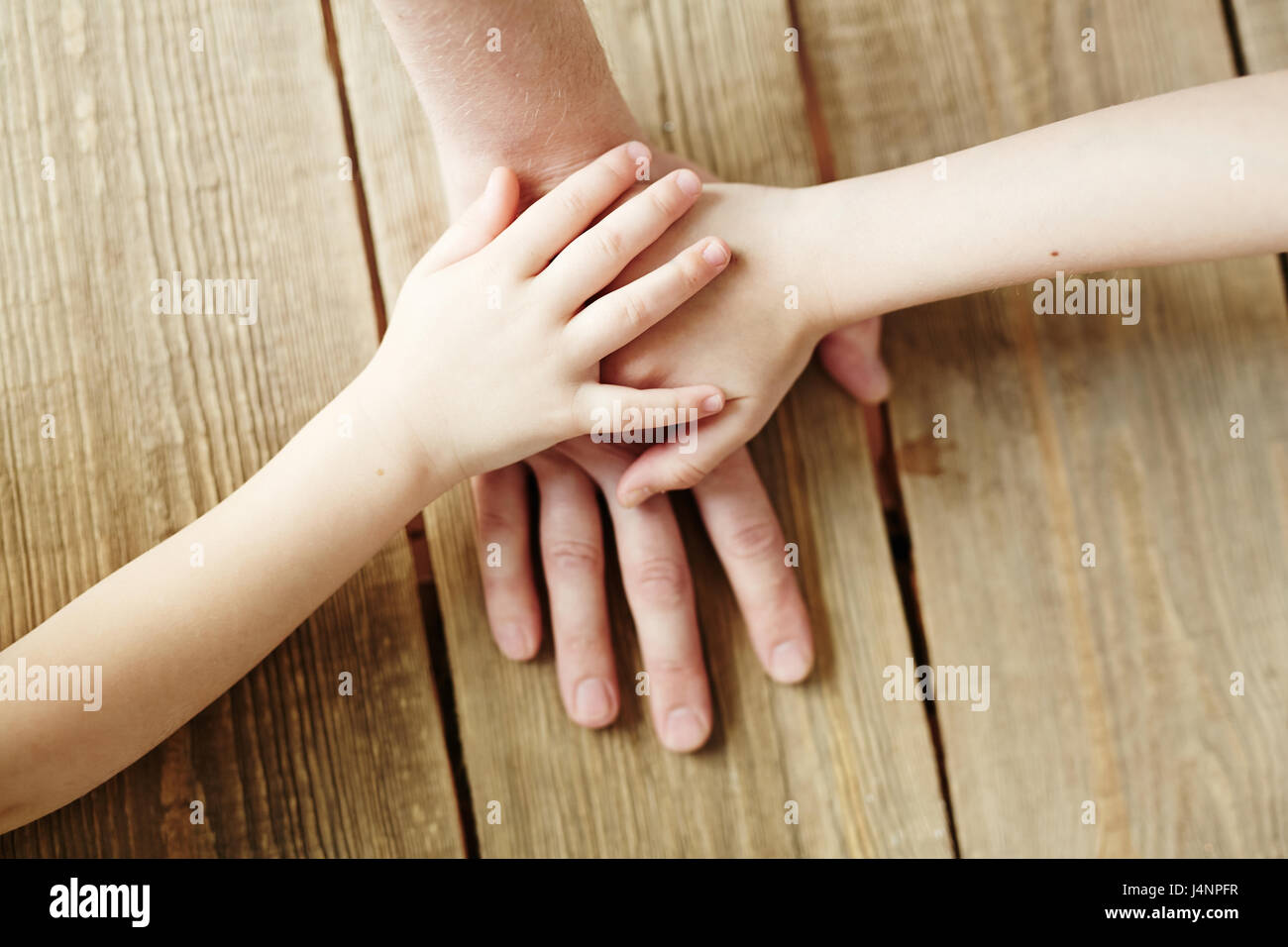 Hands of kids on that of their father Stock Photo - Alamy