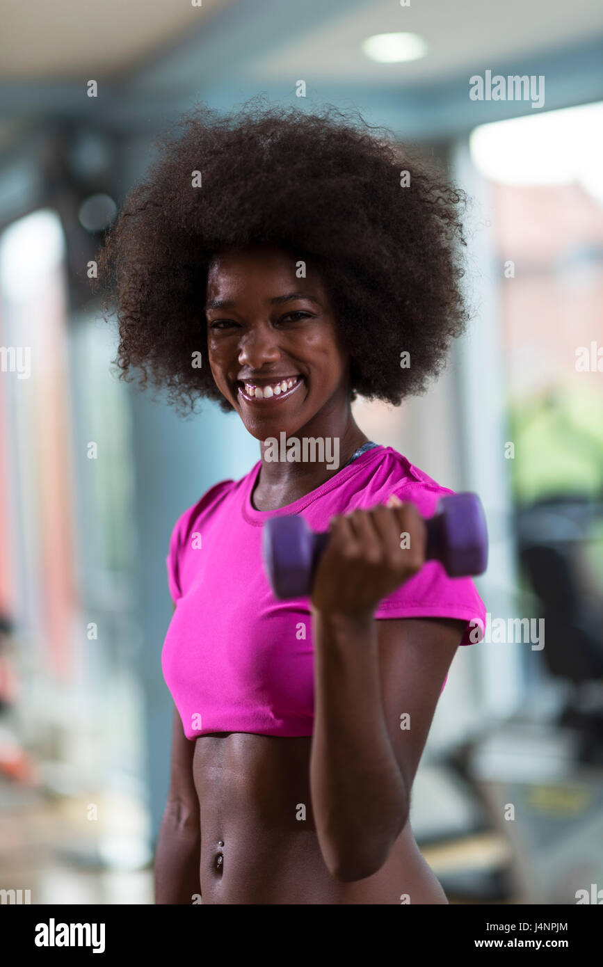 happy healthy african american woman working out in a crossfit gym on ...