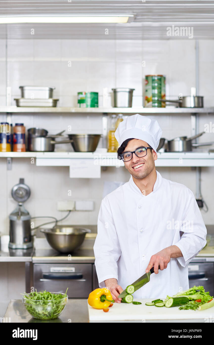 Happy chef working in the kitchen of restaurant Stock Photo - Alamy