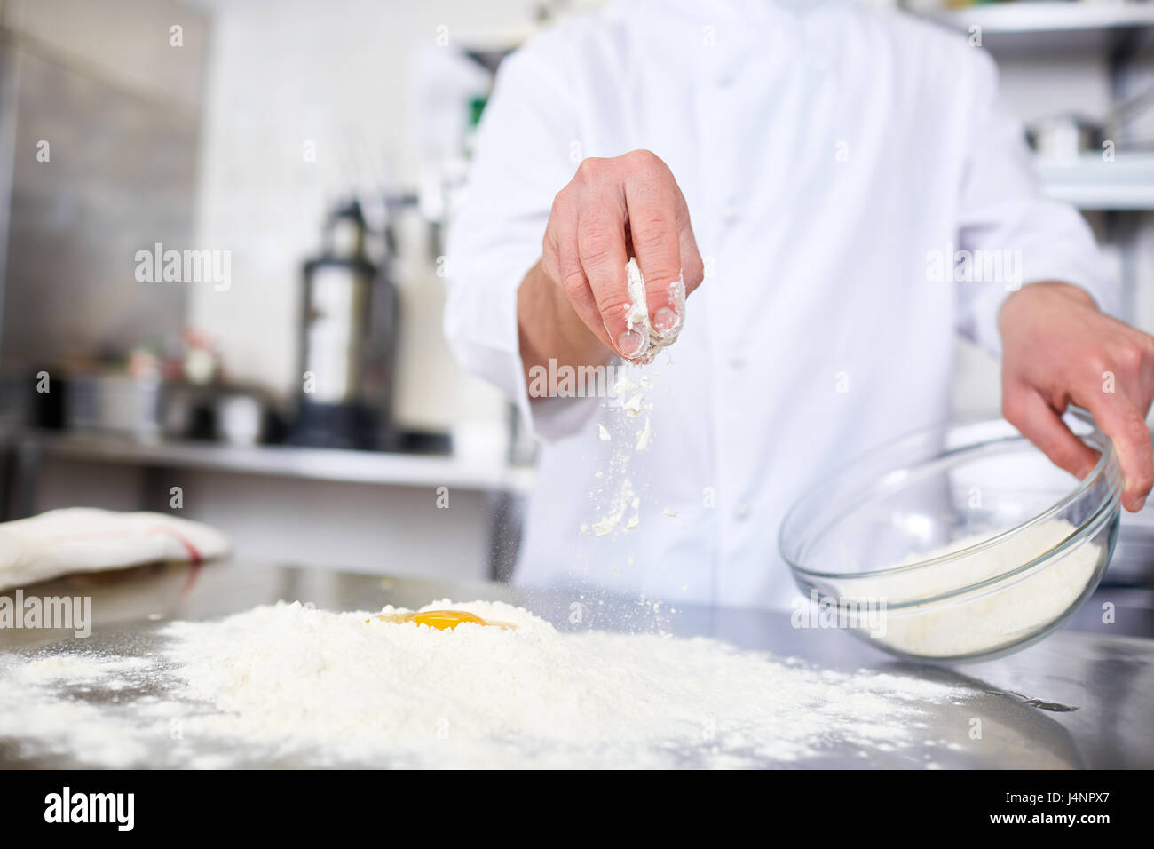 Chef working with flour and raw eggs Stock Photo - Alamy
