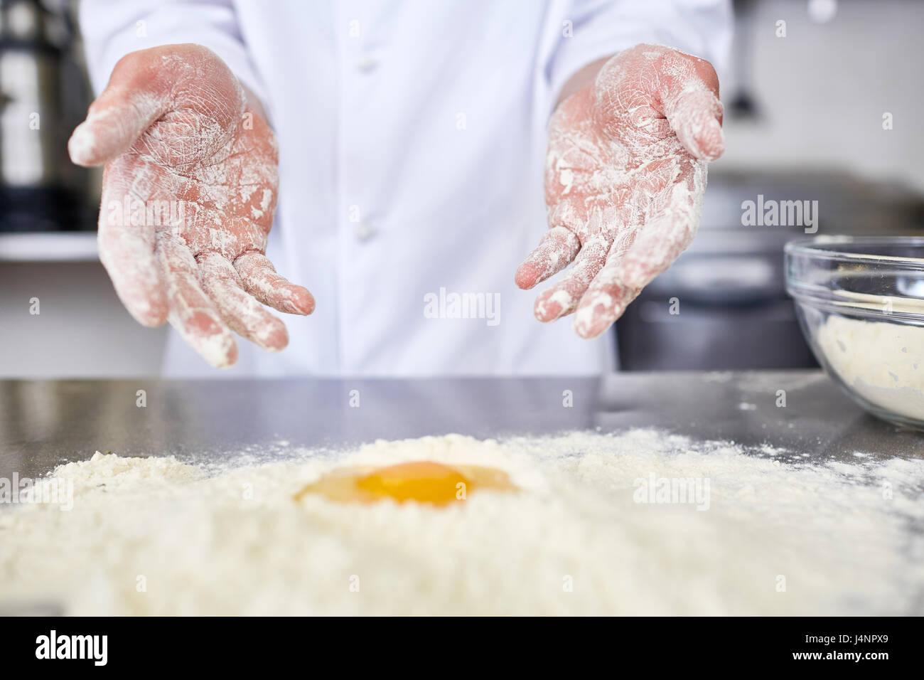 Hands of baker over workplace with pile of flour and raw yolk Stock ...